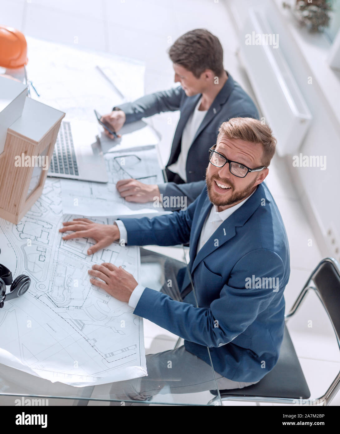 top view. employees of the architectural Bureau sitting at his Desk ...