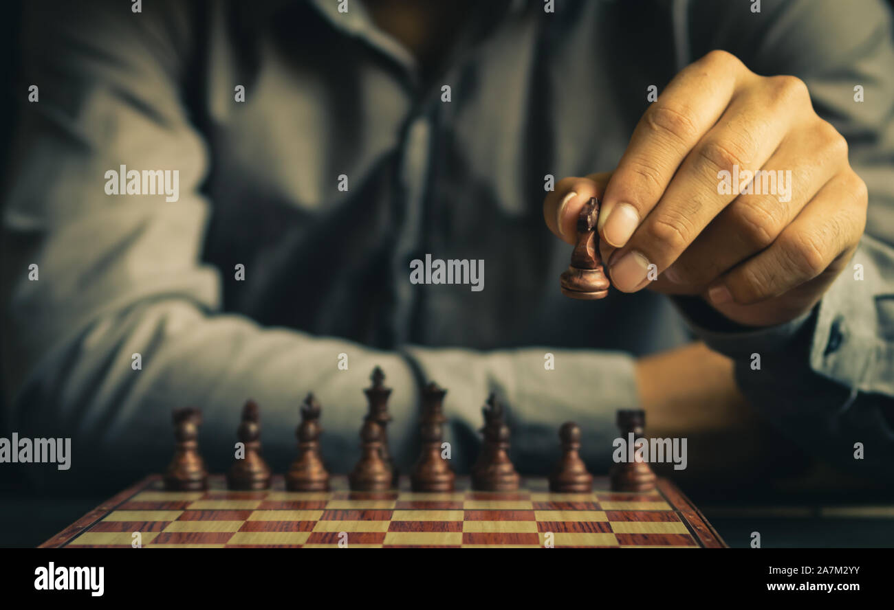 part of human hand moves chess figure on chess board in retro color ...