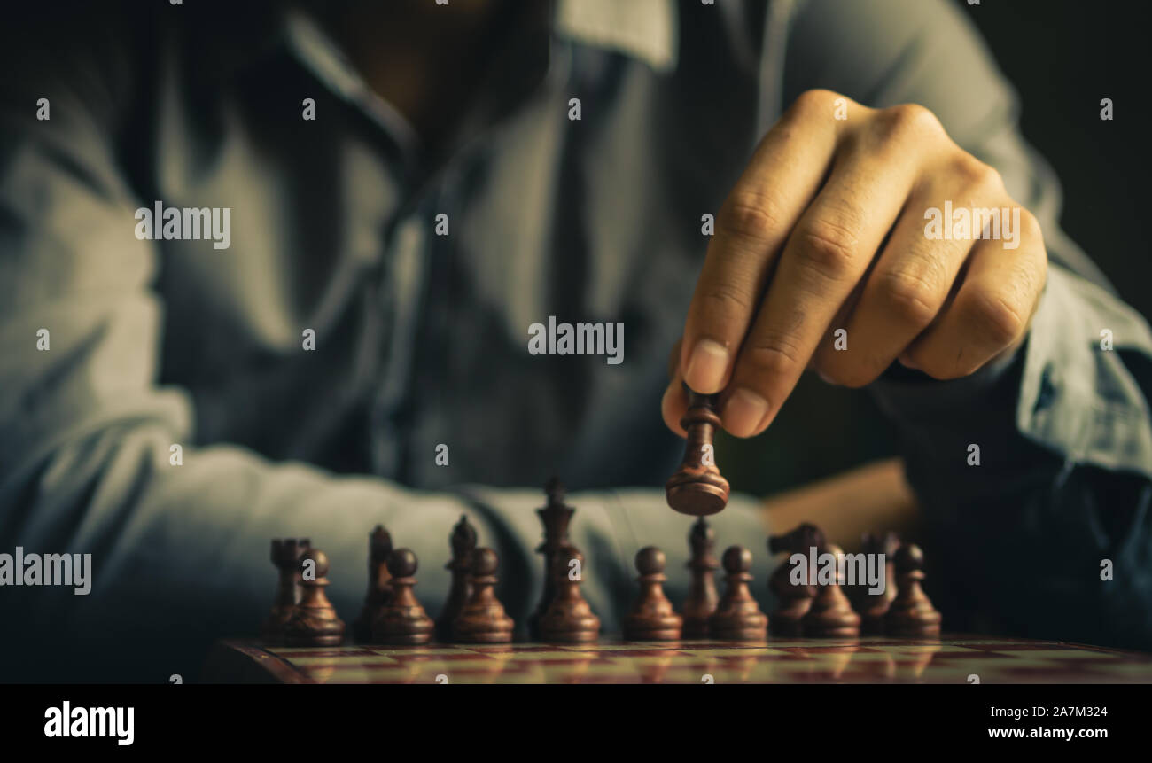 part of human hand moves chess figure on chess board in retro color ...