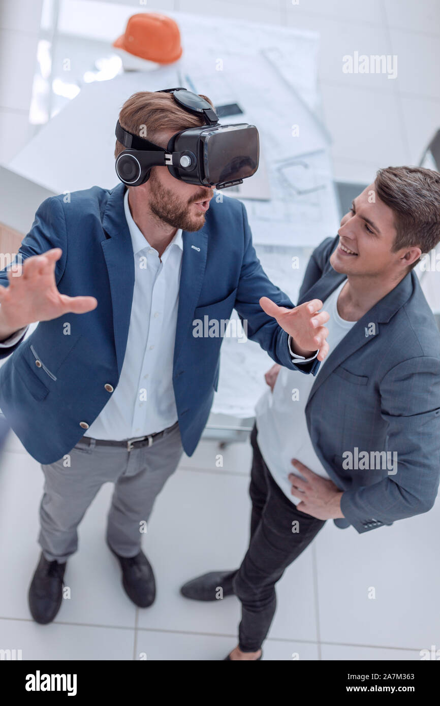 top view. smiling man looking through VR helmet Stock Photo - Alamy