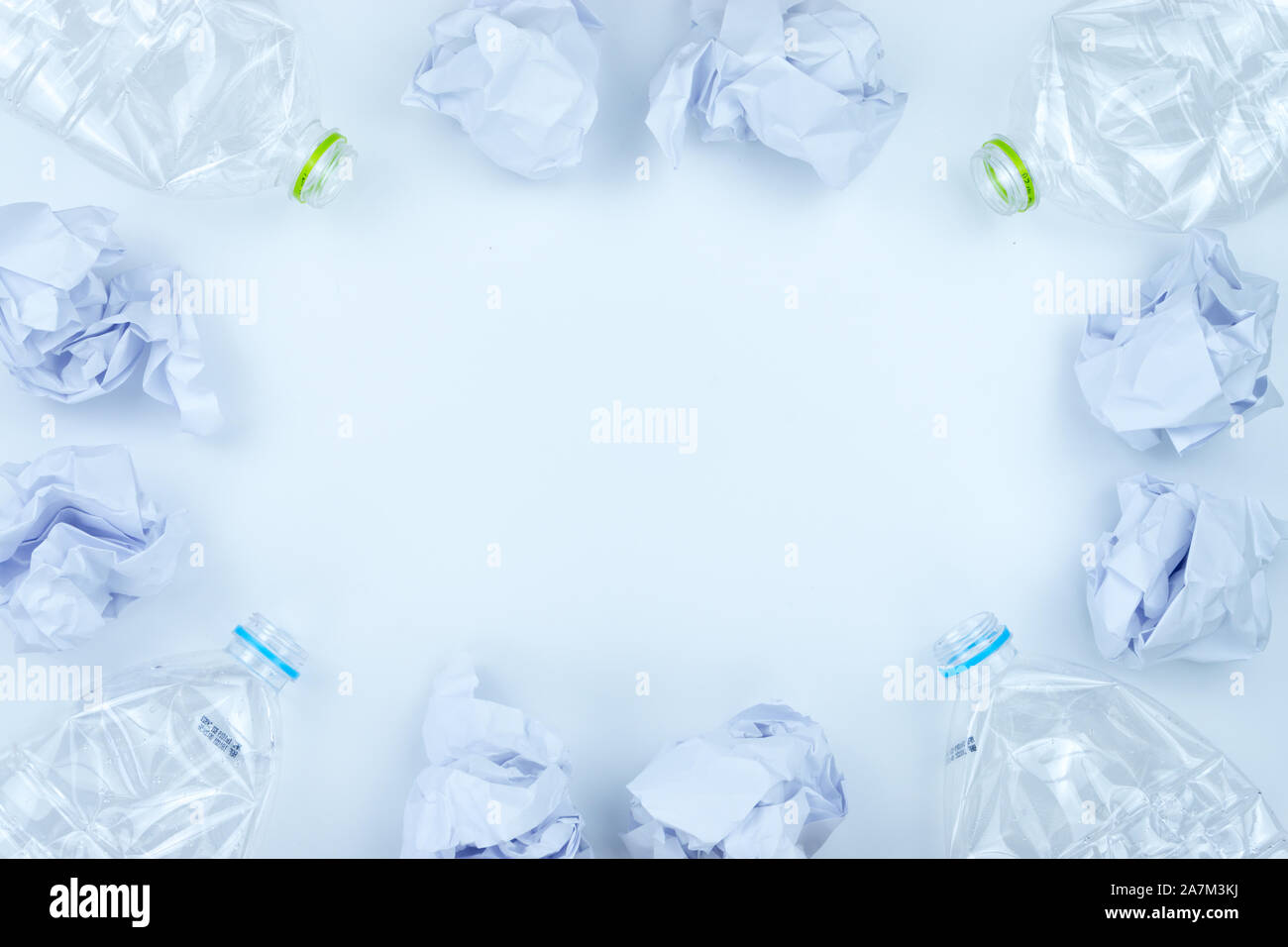 Recycling. The frame of used plastic bottle and crumpled paper on white ...