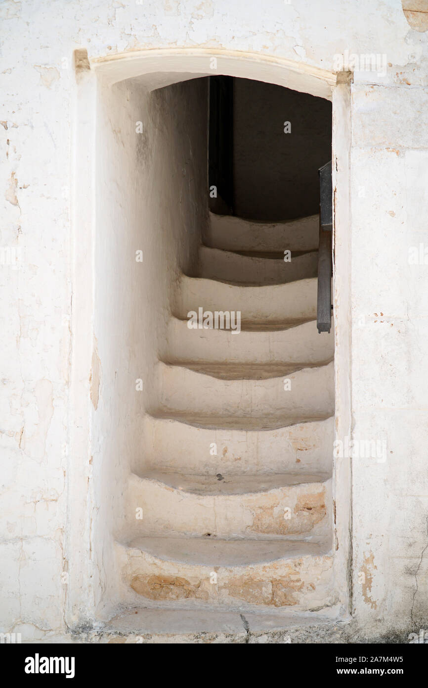 An old worn stone stairway with crumbling white plaster Stock Photo - Alamy