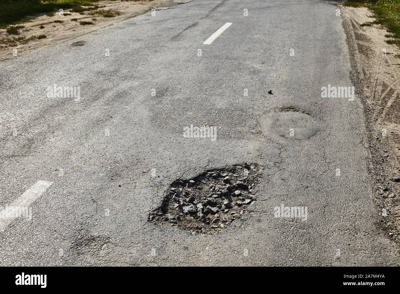 Potholes on the road Stock Photo - Alamy