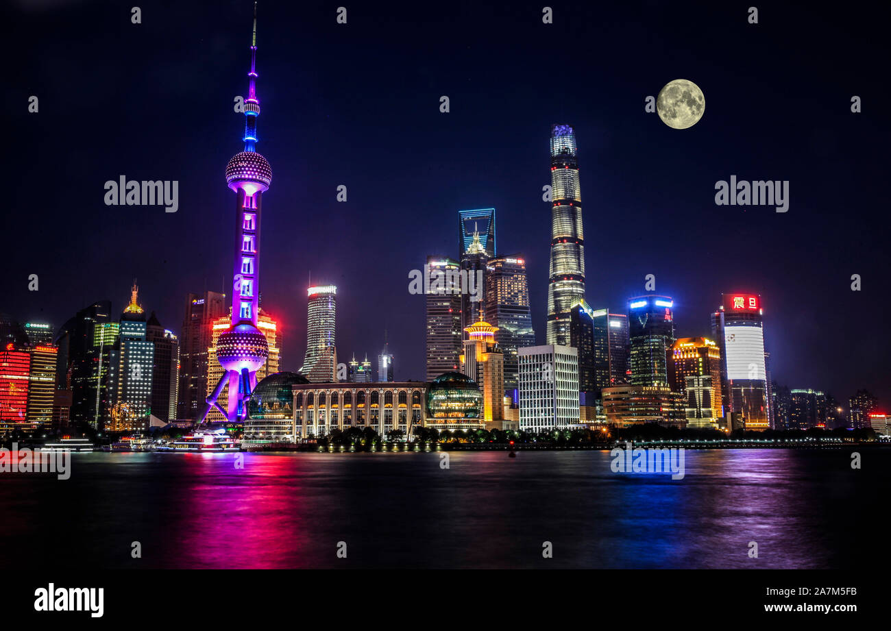 A full moon appears at the sky of the Bund, a waterfront area and ...