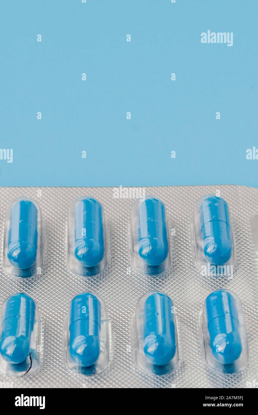 Blue capsules, pills on a blue background. Vitamins, nutritional ...