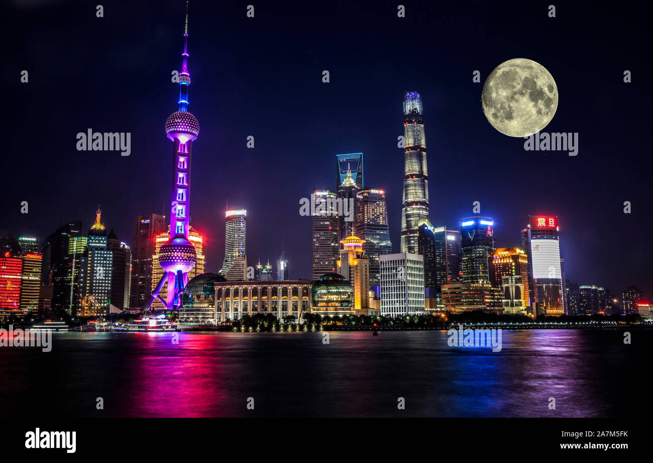 A full moon appears at the sky of the Bund, a waterfront area and ...