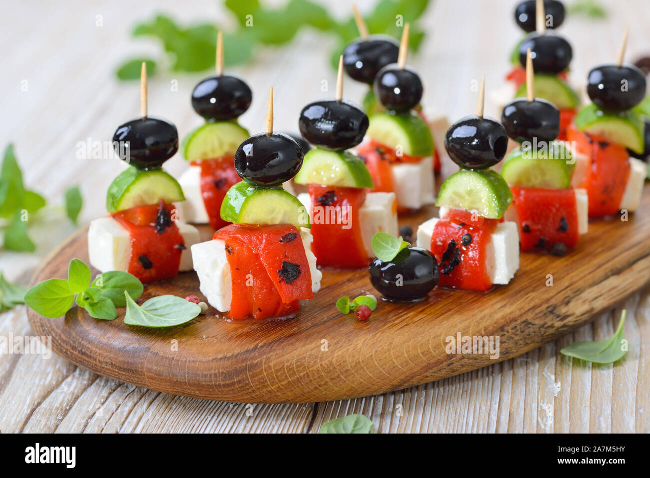 Greek appetizers: Feta cheese skewers with grilled and pickled red ...