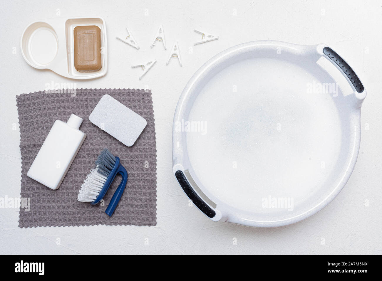 Hand wash concept. Wash basin, towel, detergent, soap, pin and brush on ...