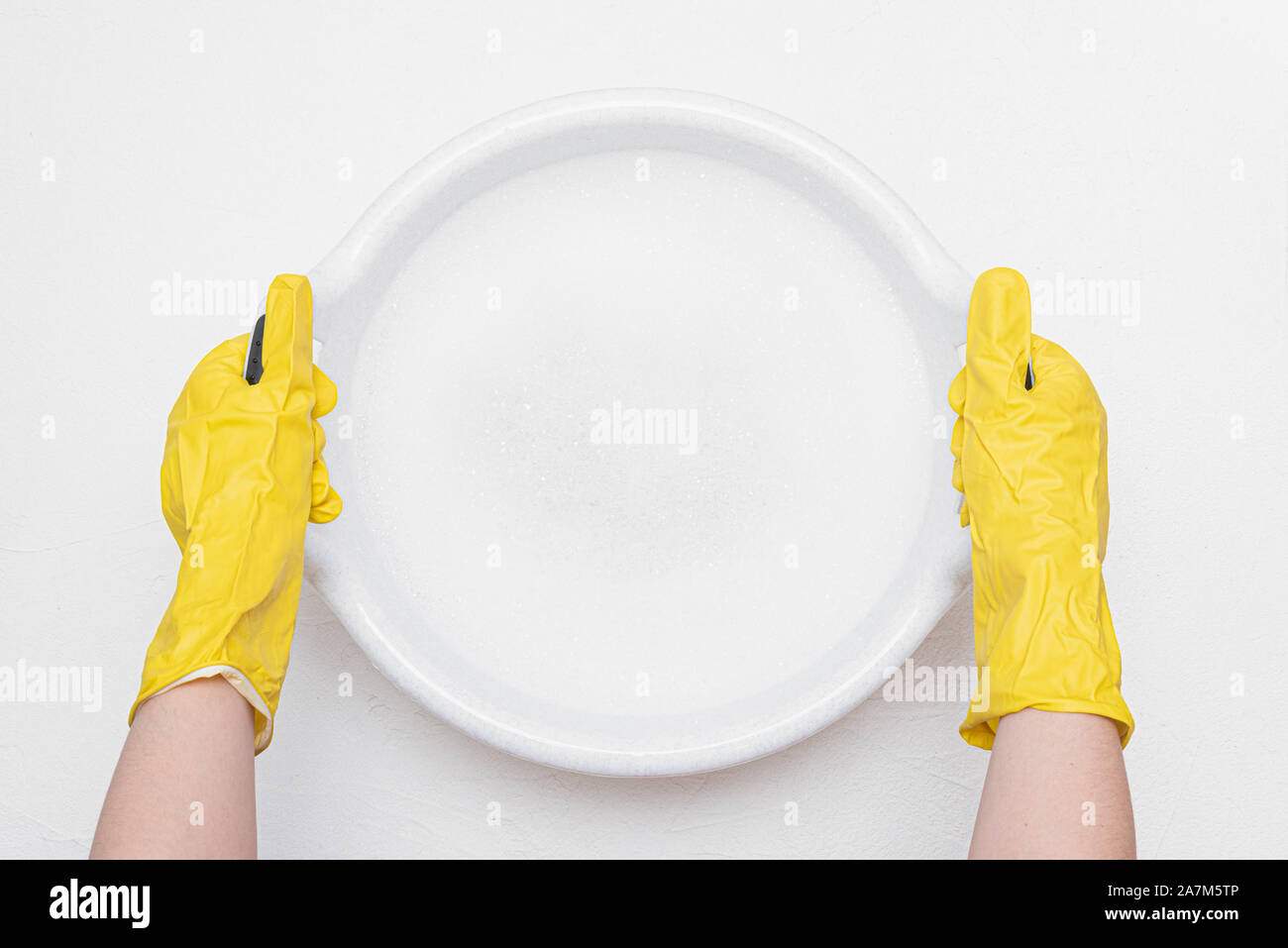 Female hands holding a wash basin with foam water flat lay background ...
