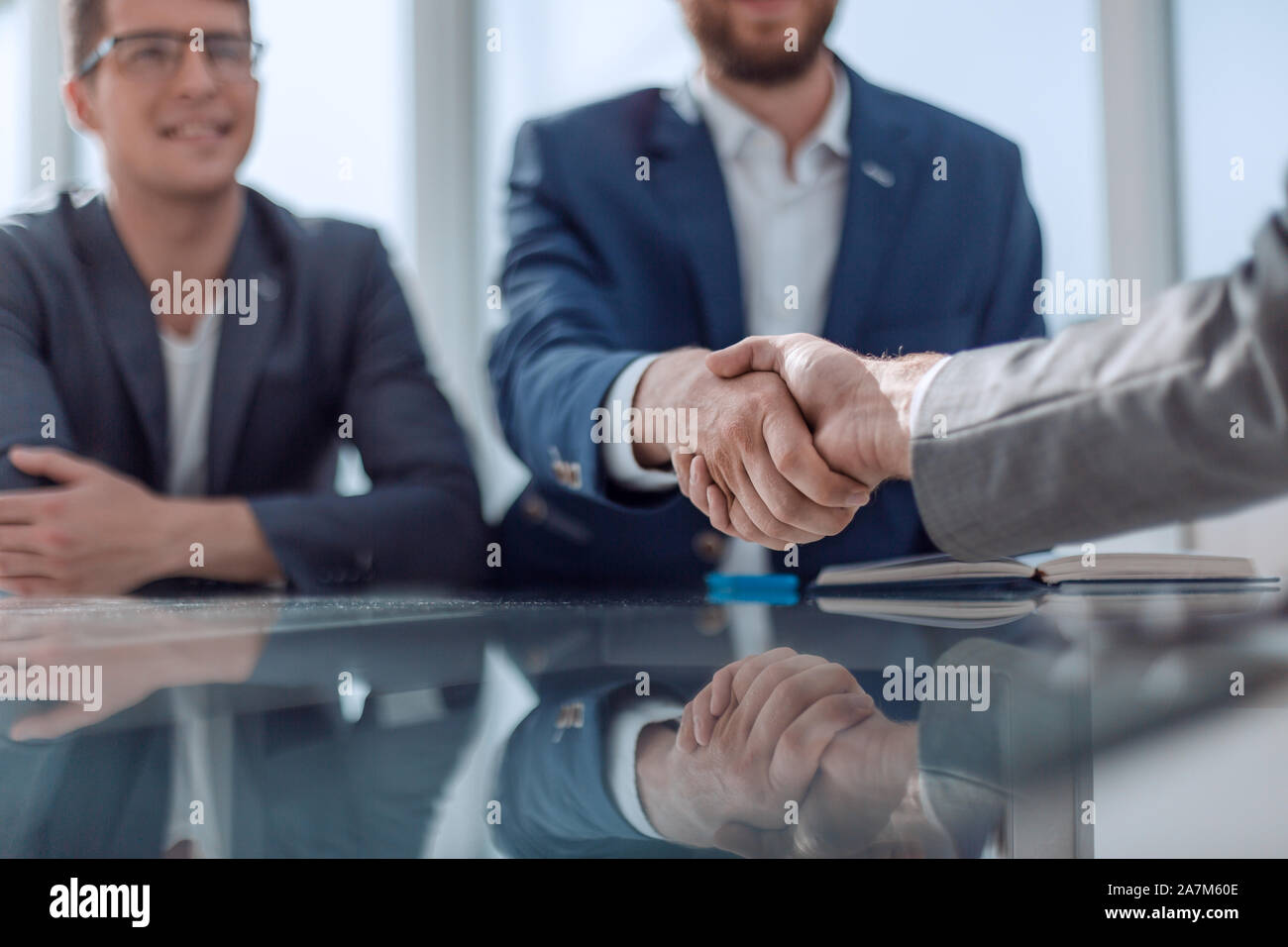 close up. business handshake over the office Desk Stock Photo - Alamy