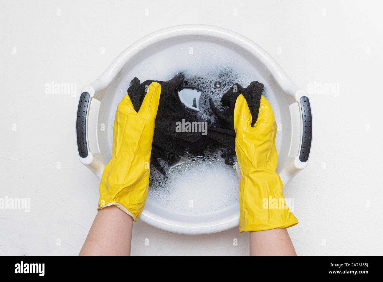 Female hands holding a wash basin with foam water flat lay background ...