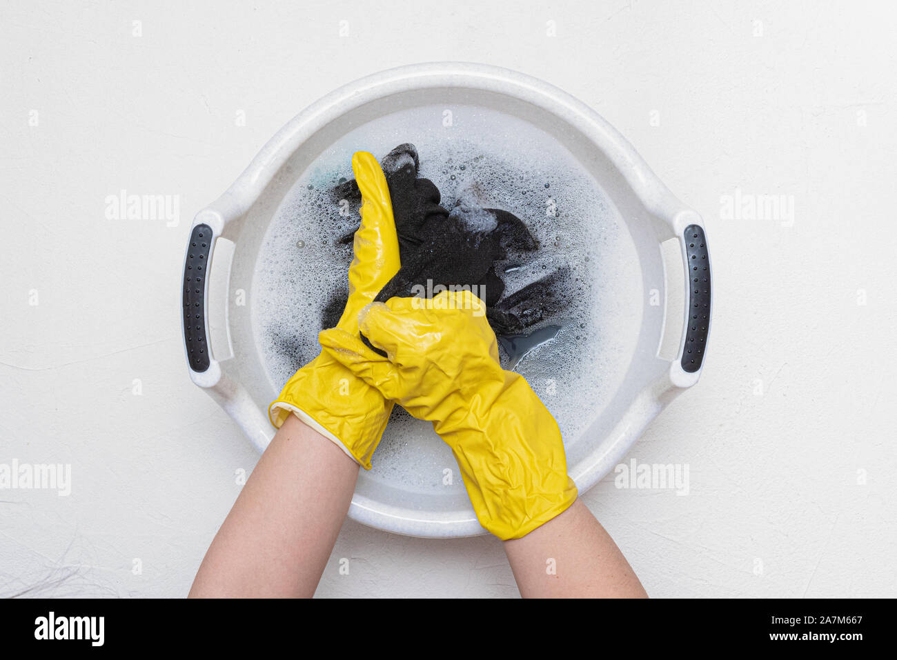 Female hands holding a wash basin with foam water flat lay background ...
