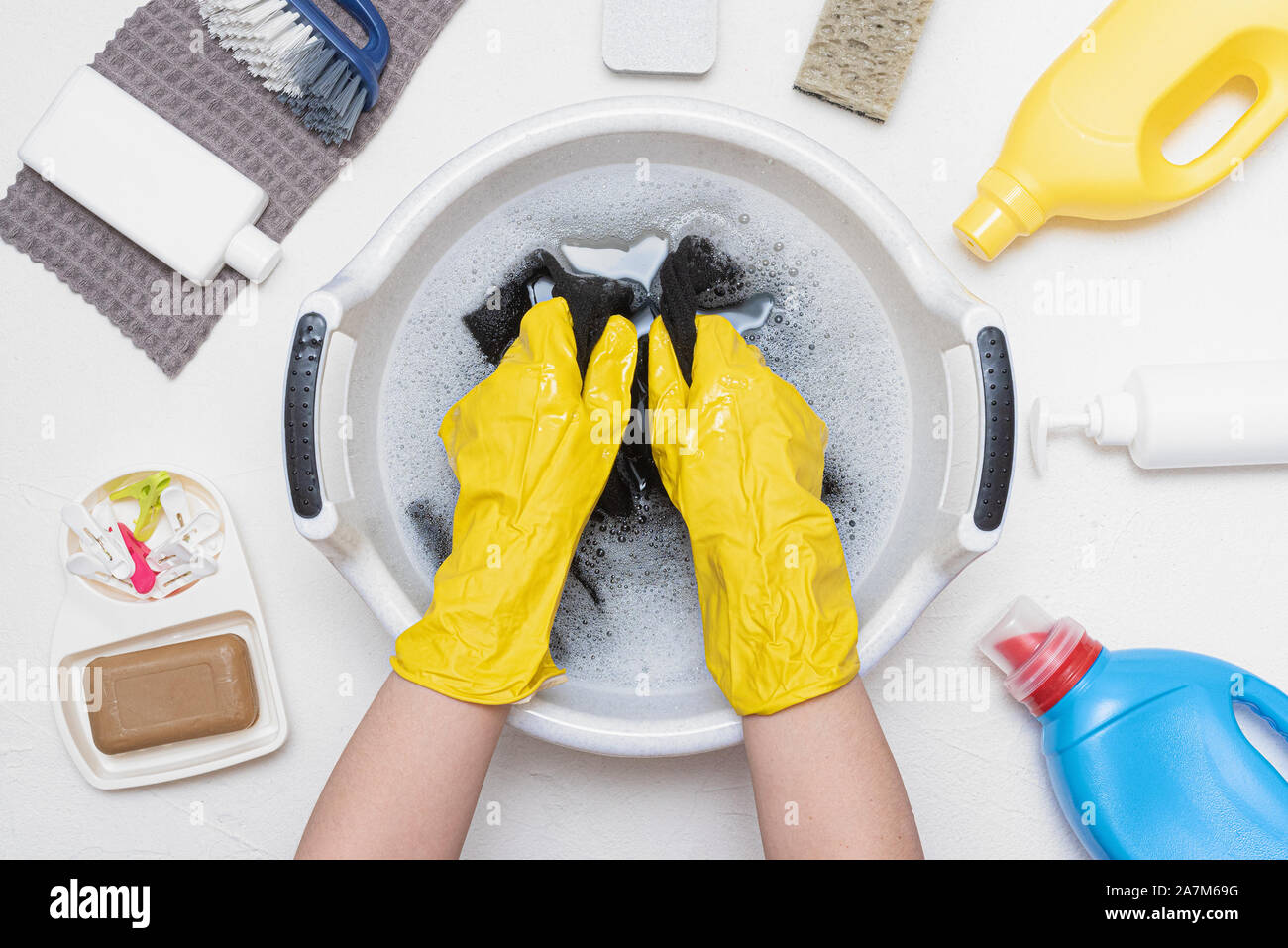 Female hands holding a wash basin with foam water flat lay background ...