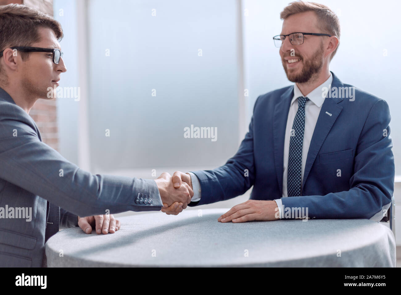 close up. business handshake over the office Desk Stock Photo - Alamy