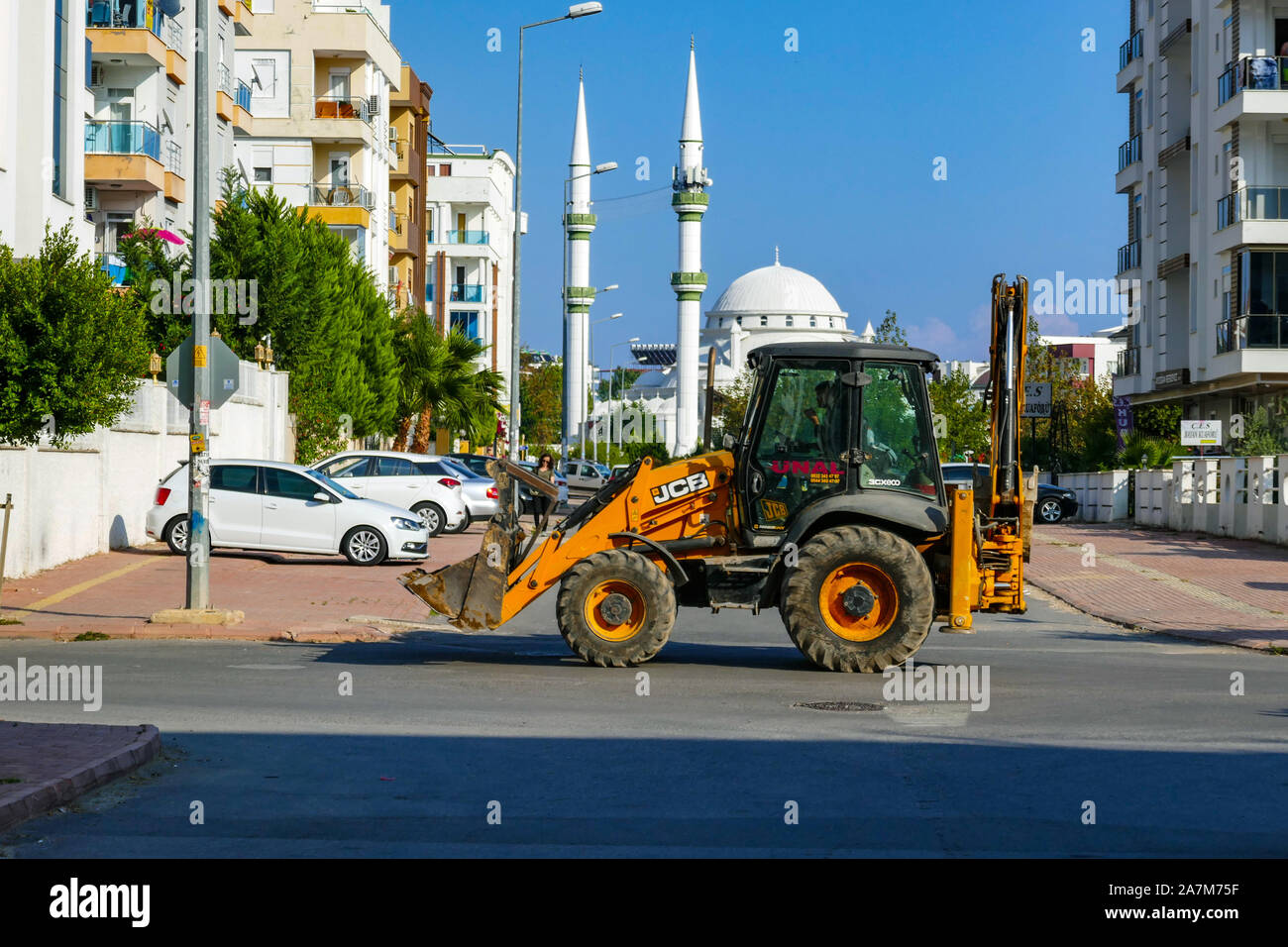 Yellow JCB digger with Mosque with minarets, Antalya, Konyaalti ...