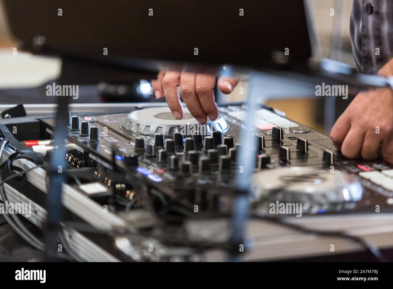Deejay uses controls at event to entertain and amuse Stock Photo - Alamy