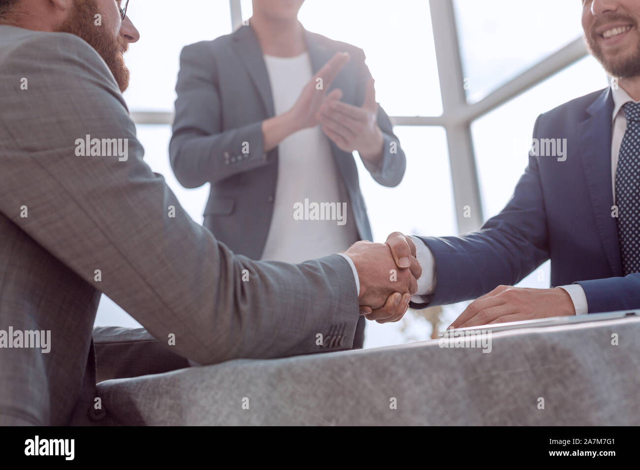 close up. smiling business partner shaking hands Stock Photo - Alamy