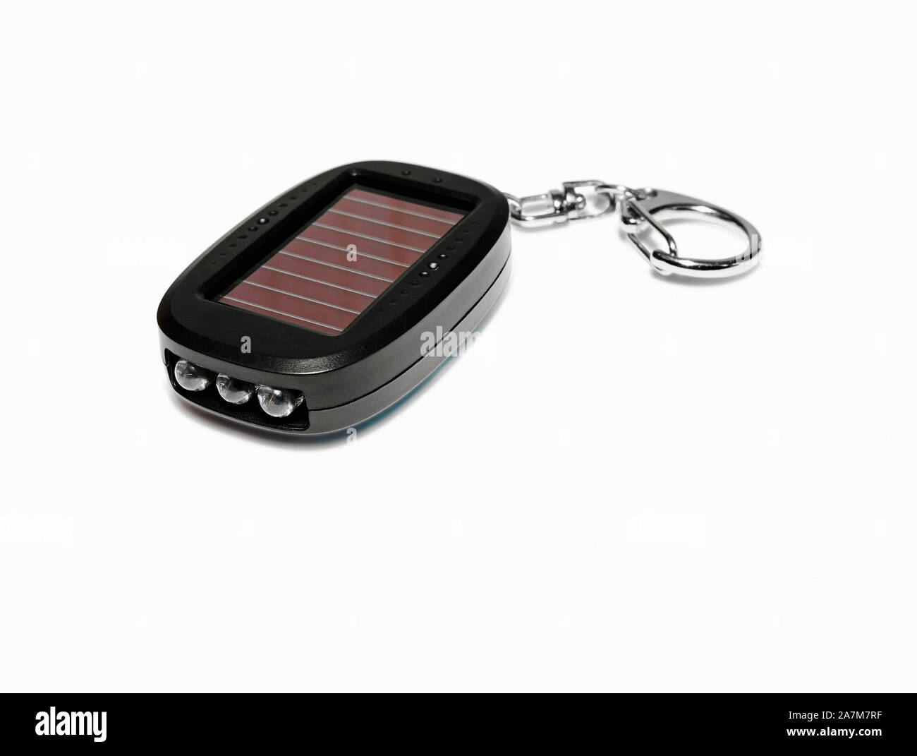 Flashlight keychain LED. Charging from the solar battery. Close-up ...
