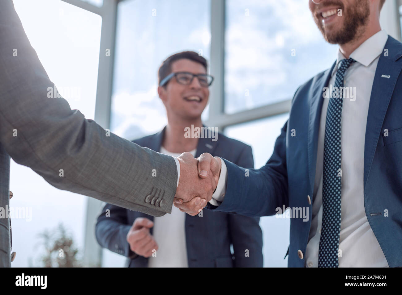 business people greet each other in the office lobby Stock Photo - Alamy