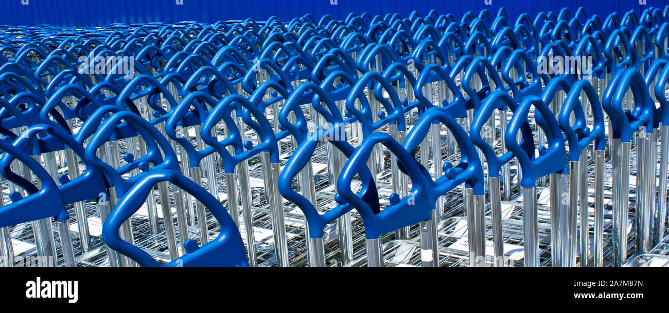 Blue shopping carts as background banner Stock Photo - Alamy