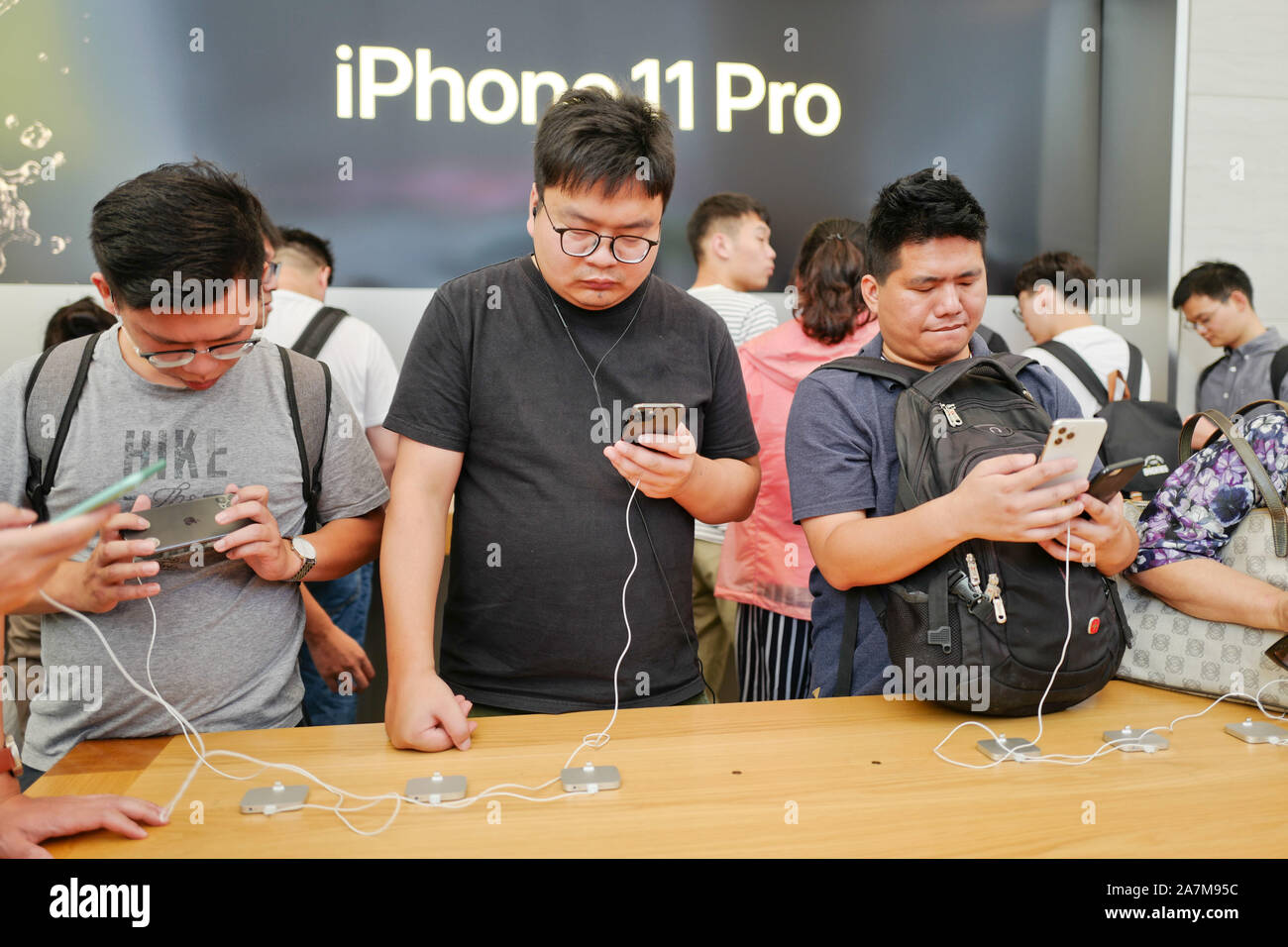Customers try out iPhone 11 series smartphones at the East Nanjing Road ...