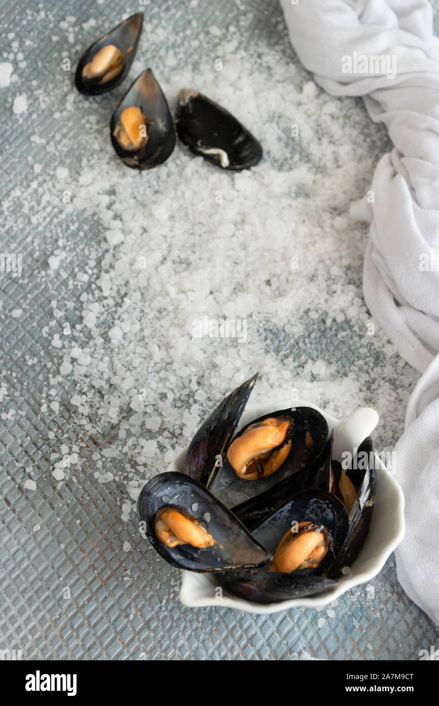 Cooked delicious black mussel, salty white background. Healthy eating ...