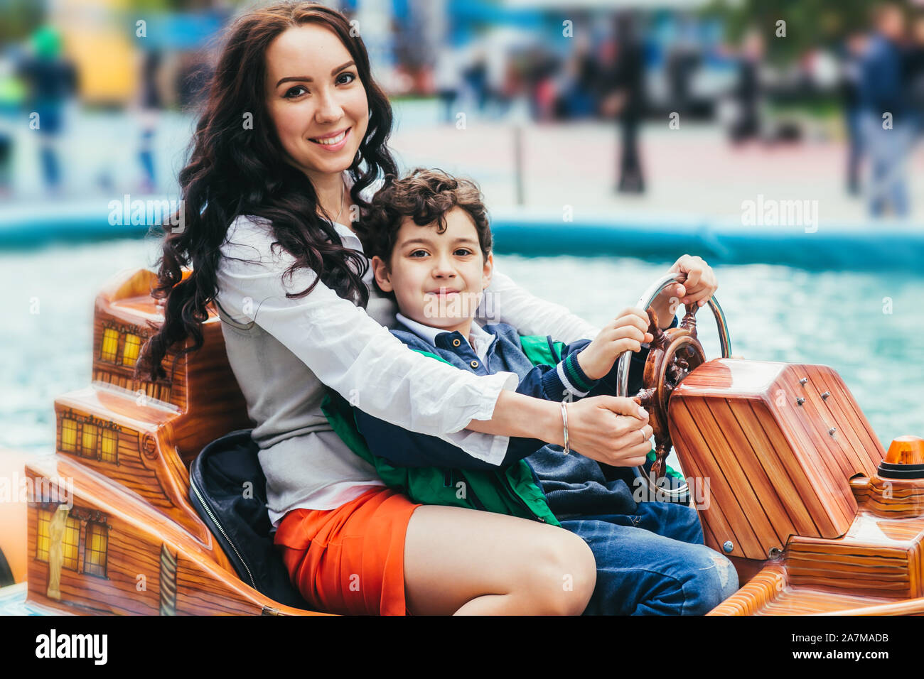 Happy family in the amusement park in summer Stock Photo - Alamy