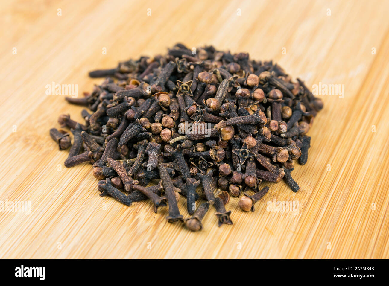 Whole clove heads and pieces isolated over white Stock Photo - Alamy