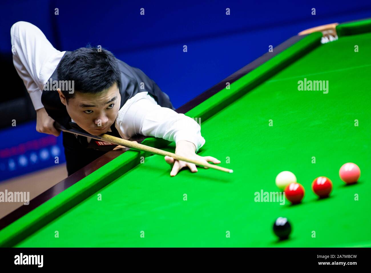 Chinese professional snooker player Ding Junhui plays a shot at the ...