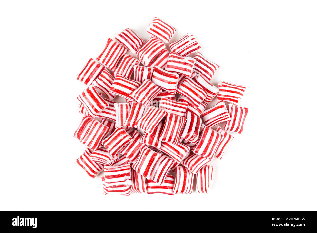 Red and white striped holiday candy isolated over white Stock Photo - Alamy