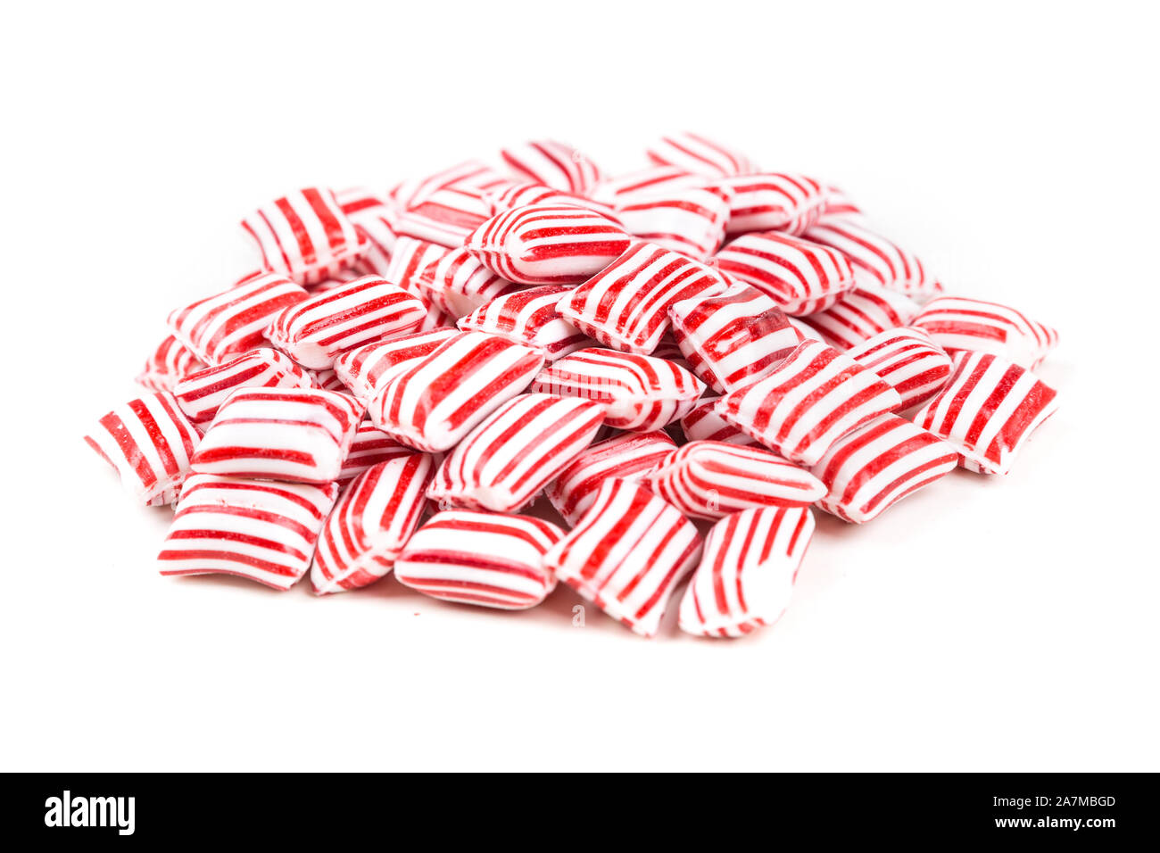 Red and white striped holiday candy isolated over white Stock Photo - Alamy