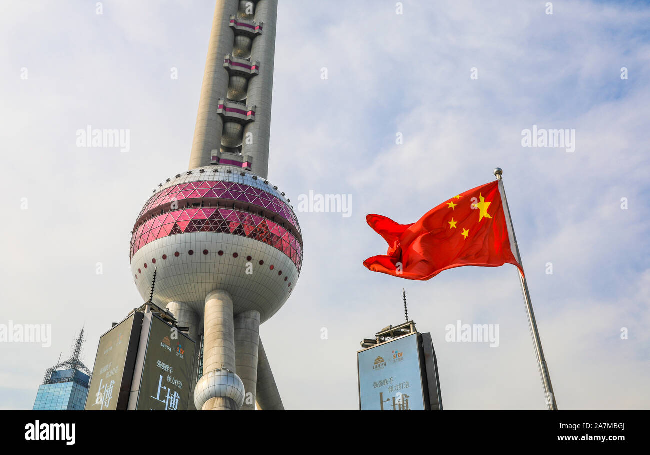 National flags fly with the background of the Oriental Pearl Radio ...