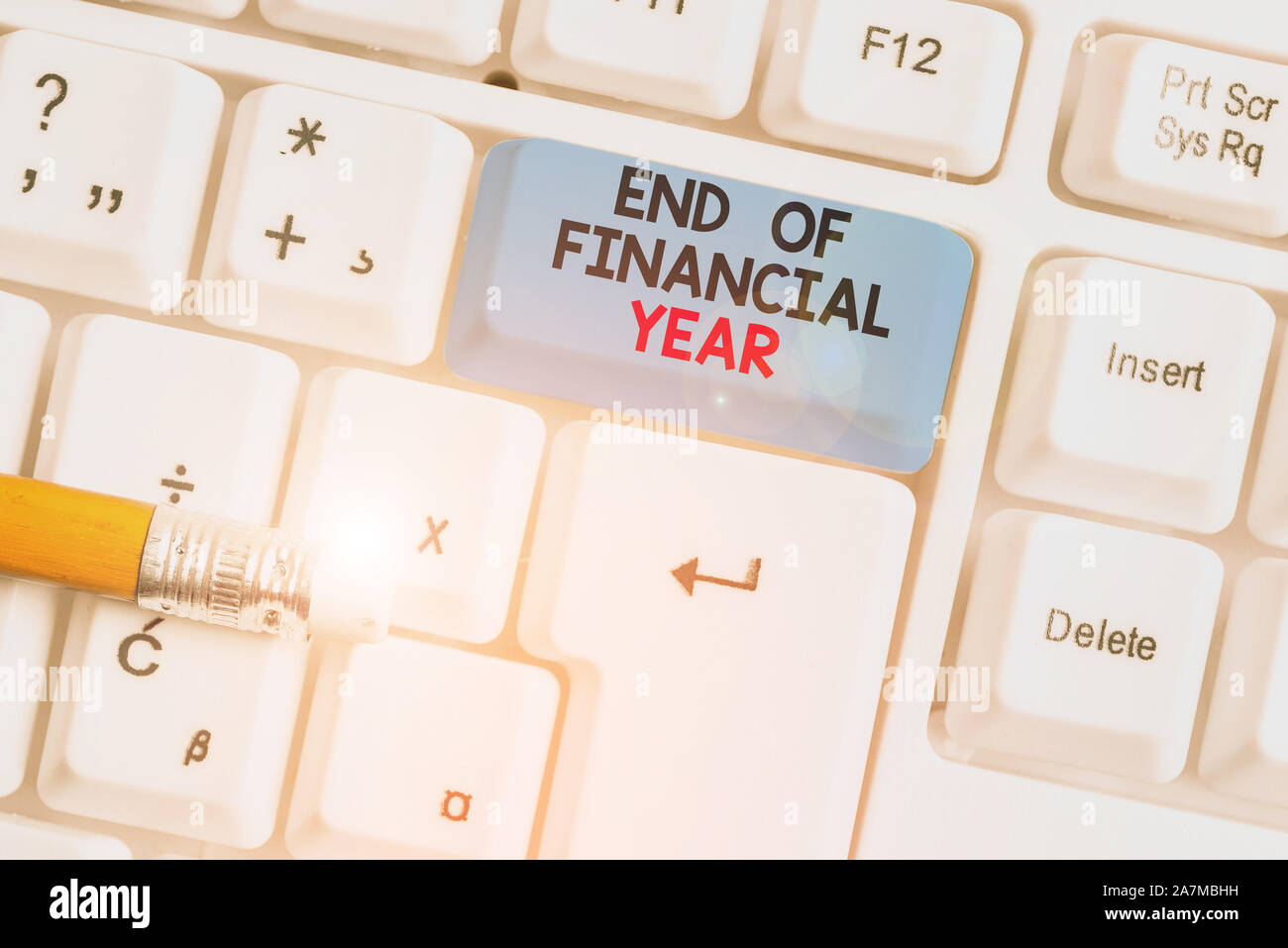 Writing note showing End Of Financial Year. Business concept for Revise ...