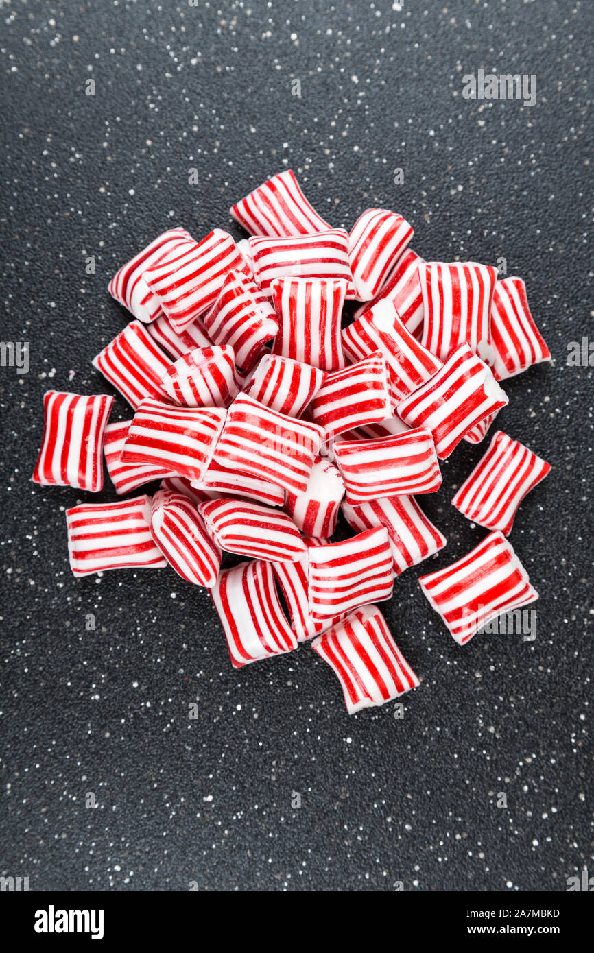 Red and white striped holiday candy isolated over white Stock Photo - Alamy