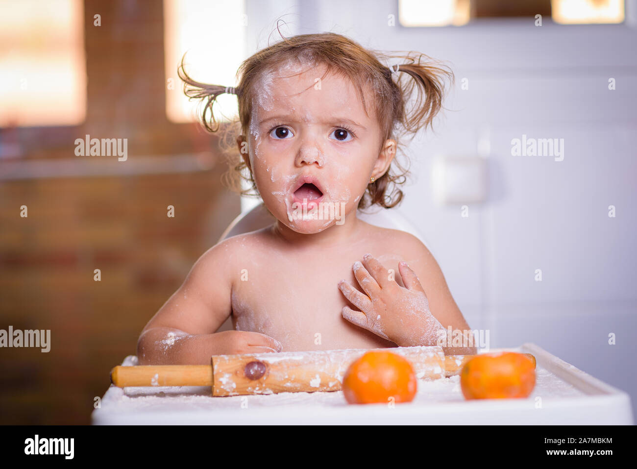 Cooking is fun. Little girl playing with flour Stock Photo - Alamy