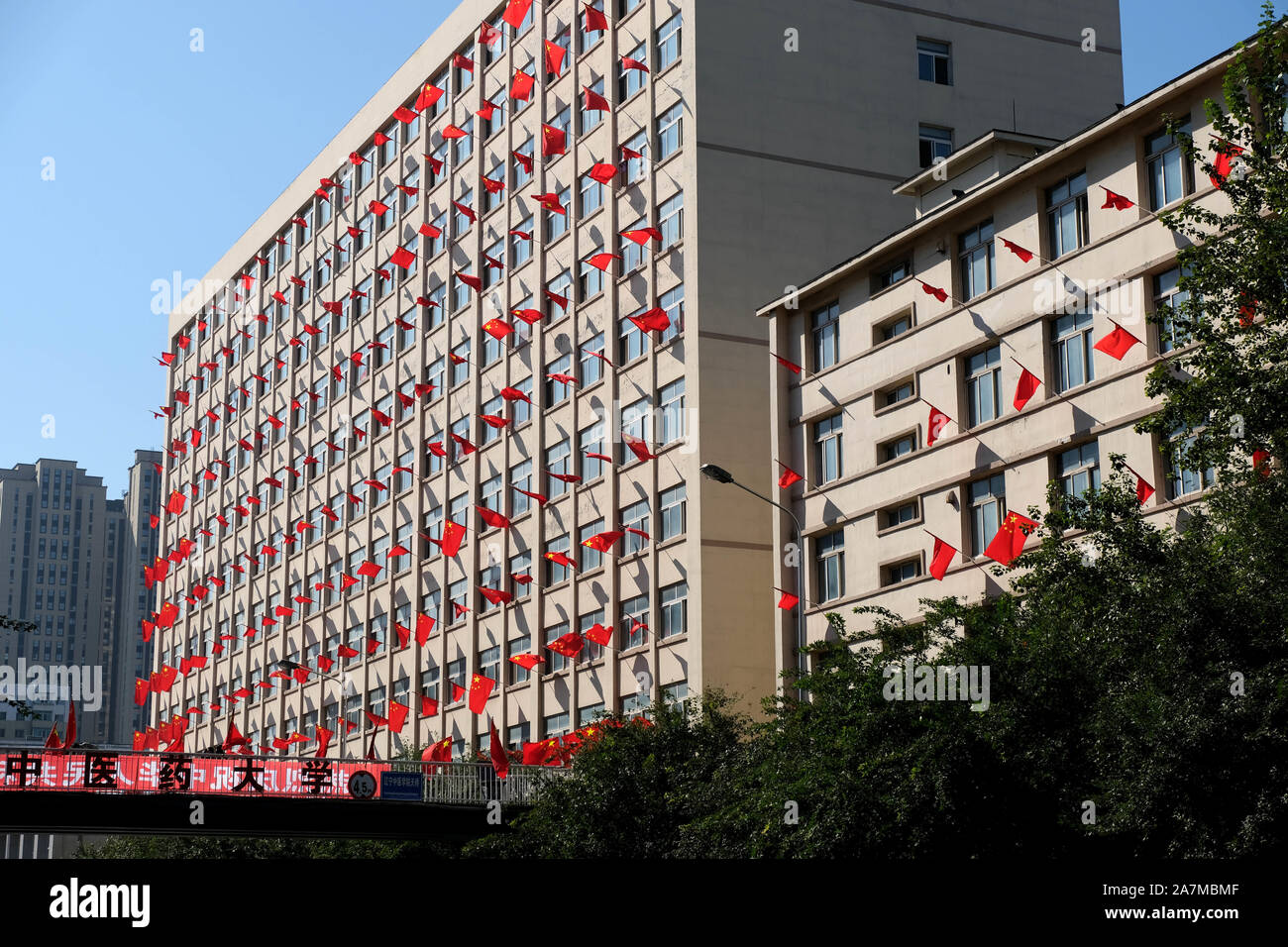 Chinese national flags flutter on the windows at the campus of Liaoning ...