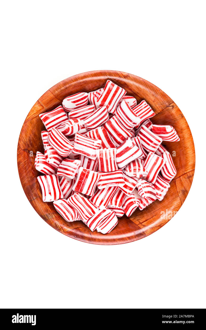 Red and white striped holiday candy isolated over white Stock Photo - Alamy