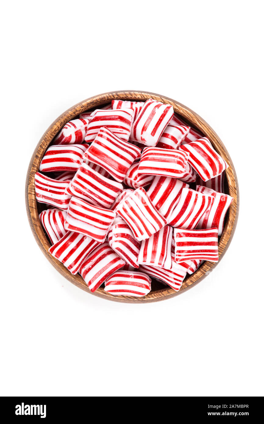 Red and white striped holiday candy isolated over white Stock Photo - Alamy