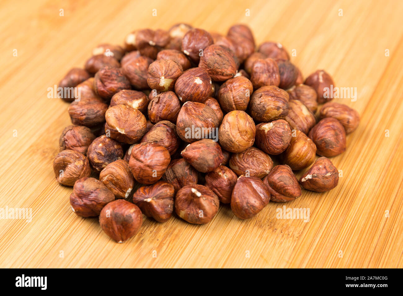 Pile of whole unshelled hazelnuts isolated Stock Photo - Alamy