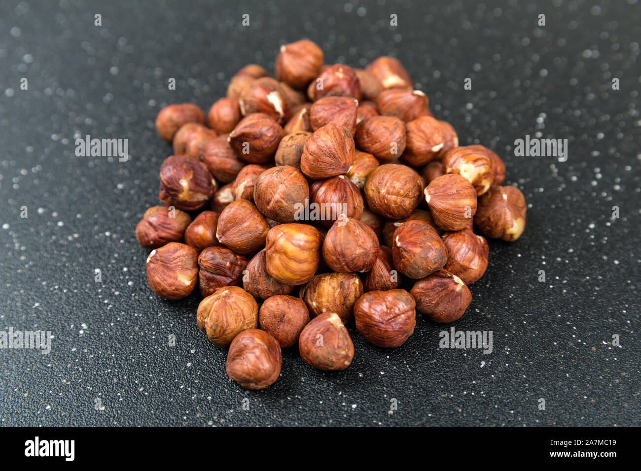 Pile of whole unshelled hazelnuts isolated Stock Photo - Alamy