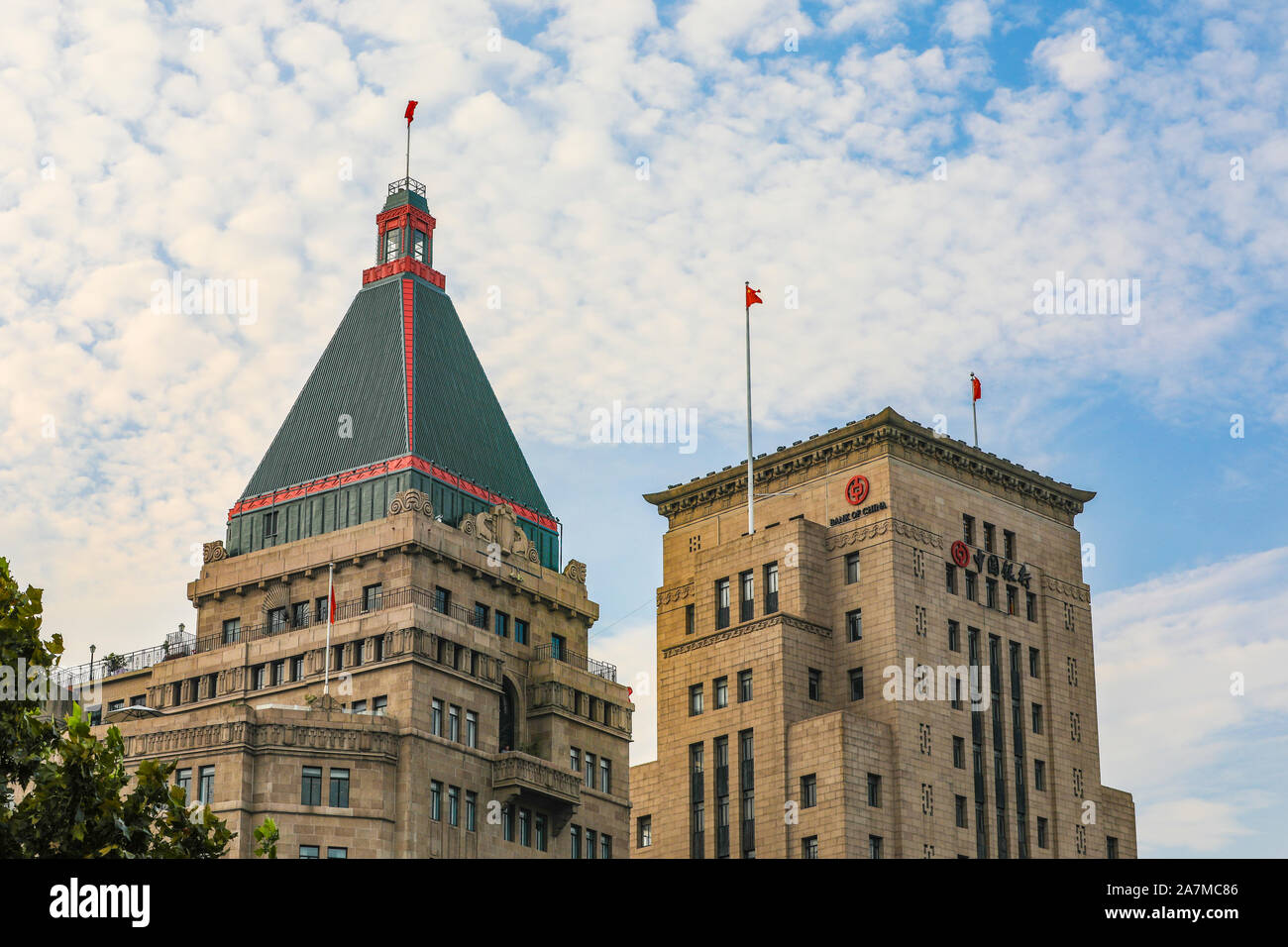 National flags fly at the Bund, a waterfront area, with the background ...