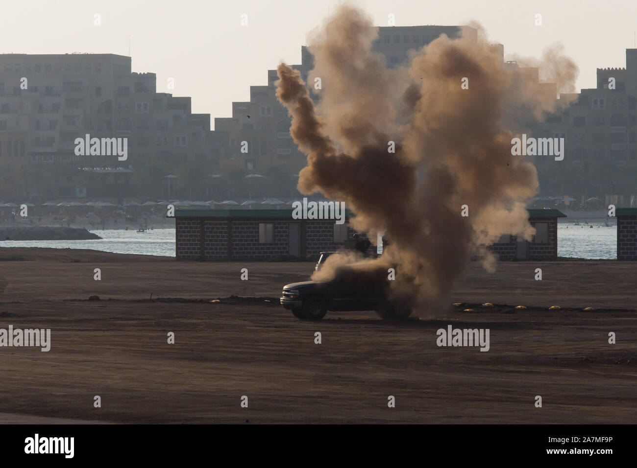Military strike or bomb on a car in war causes explosion and smoke amid ...