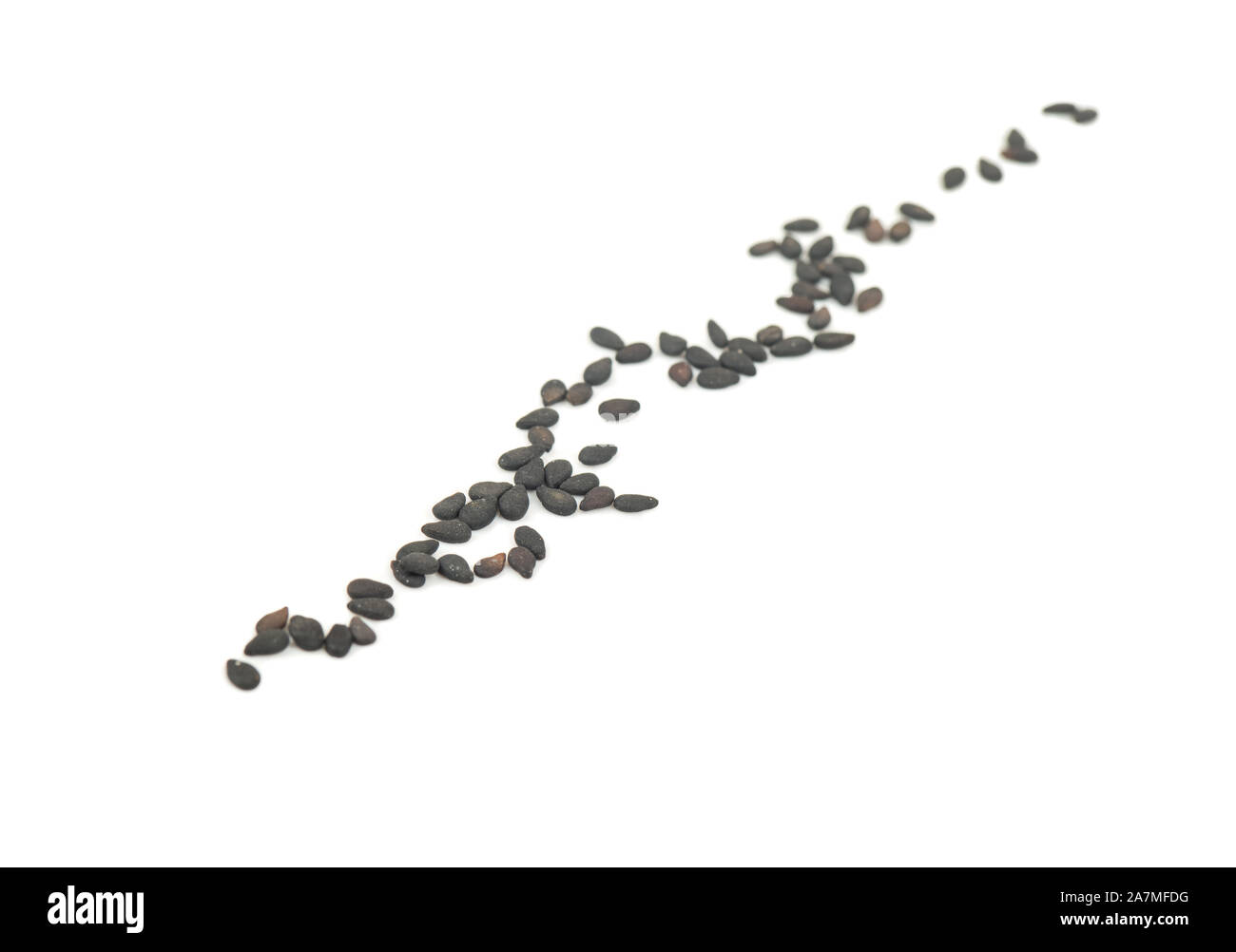 Scattered black sesame seeds on white background Stock Photo - Alamy