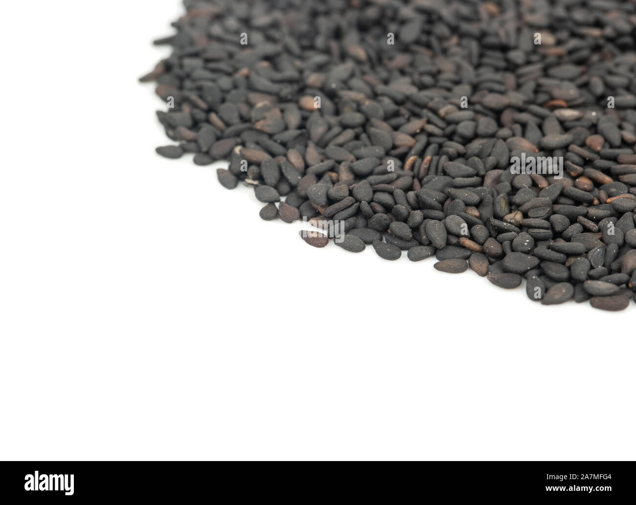 Scattered black sesame seeds on white background Stock Photo - Alamy