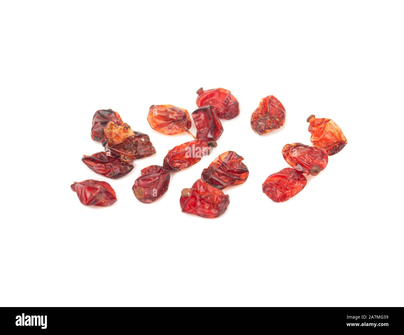 Scattered dry red barberry on a white background Stock Photo - Alamy