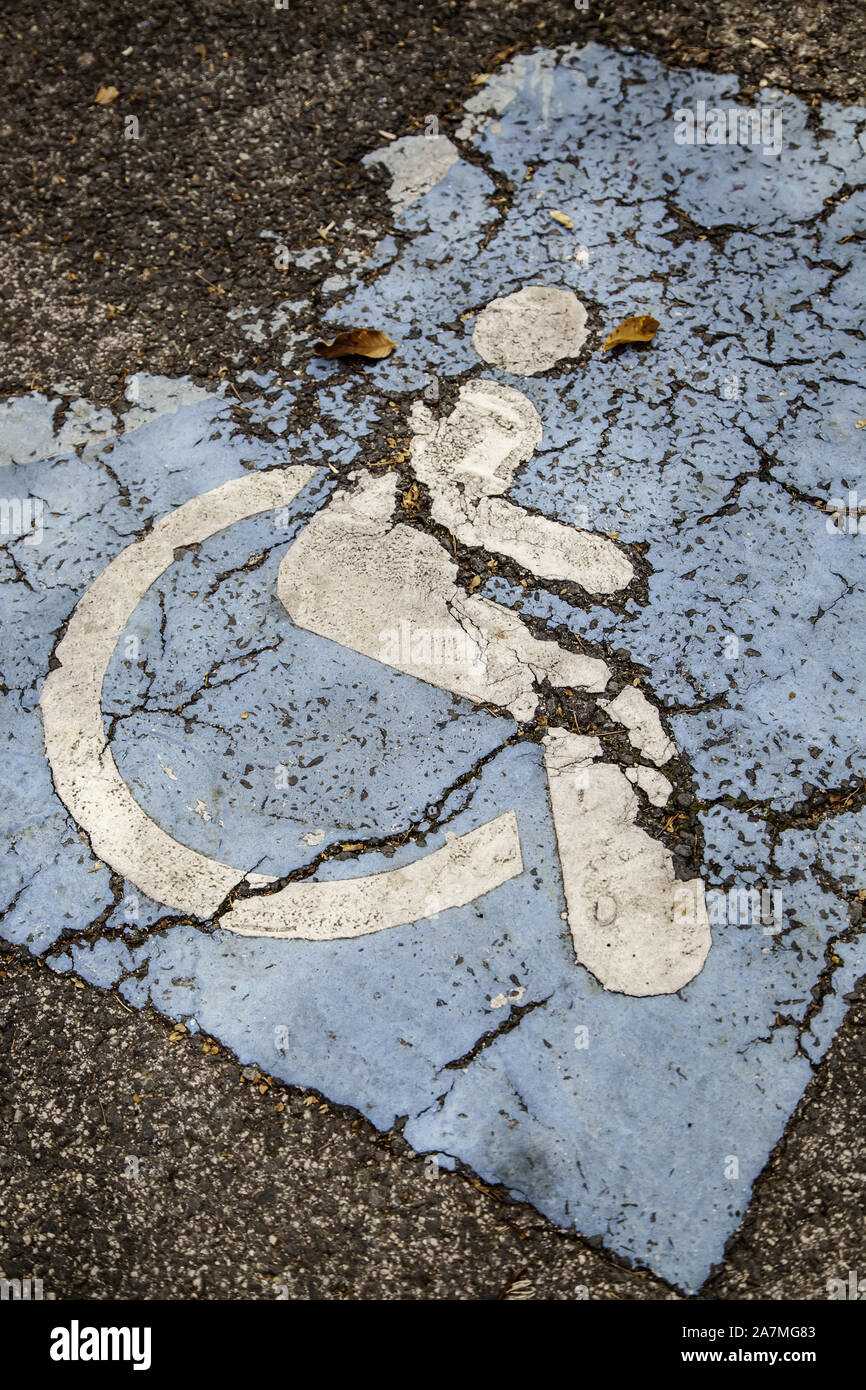 Disabled sign on the asphalt, detail of social integration, facilities ...
