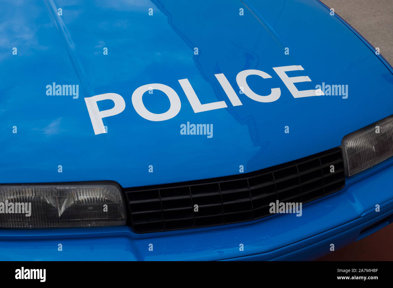 Detail of the "police" inscription on the hood of a historic police car ...