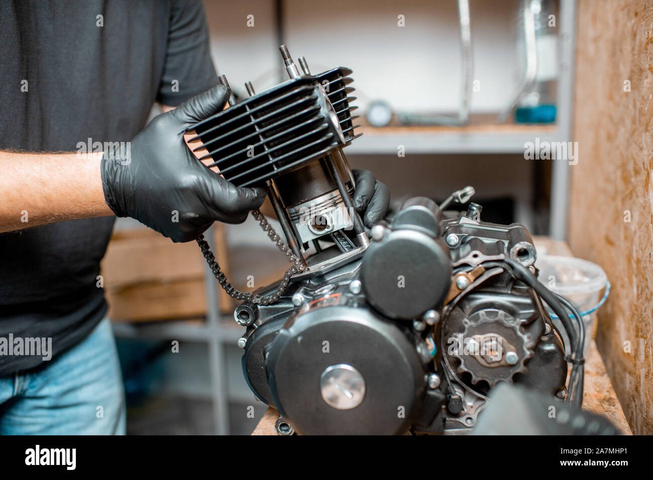 Workman disassembling motorcycle engine during a repairment at the ...
