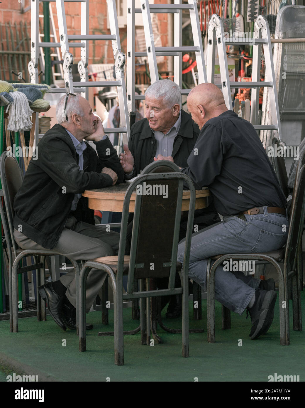 Old man in Pristina street having a conversation. Everyday Kosovo Stock ...
