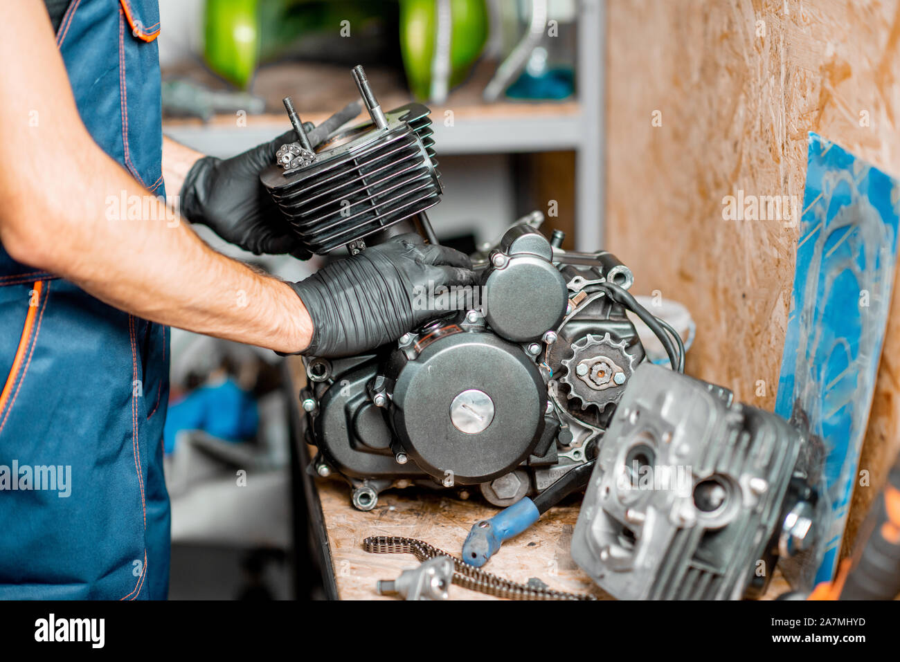 Workman disassembling motorcycle engine during a repairment at the ...